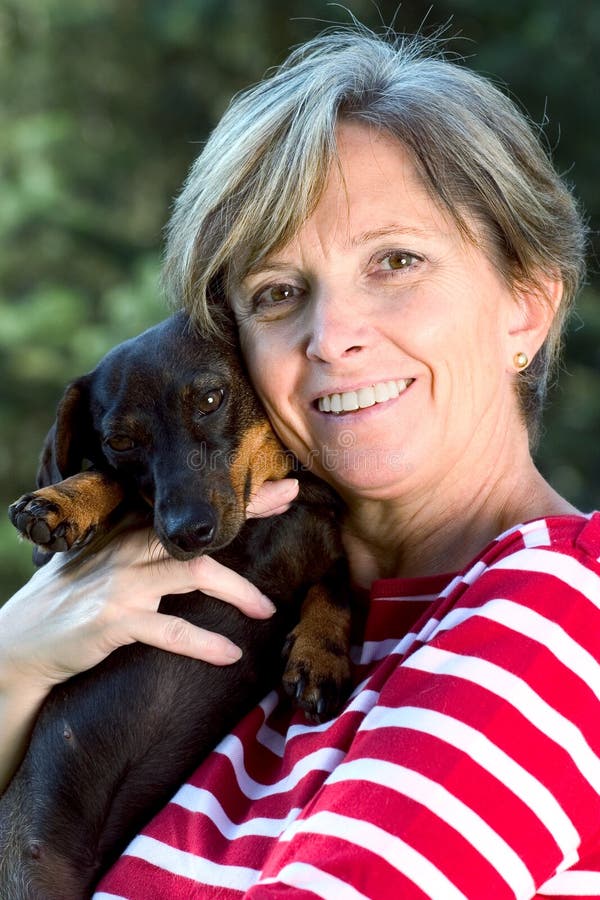 Woman holding a dog stock photo. Image of aged, laugh - 1182832