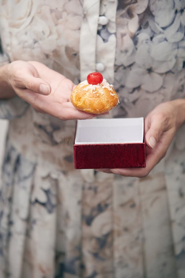 Woman Holding Eclair and Red Box Stock Photo - Image of limb, hand ...