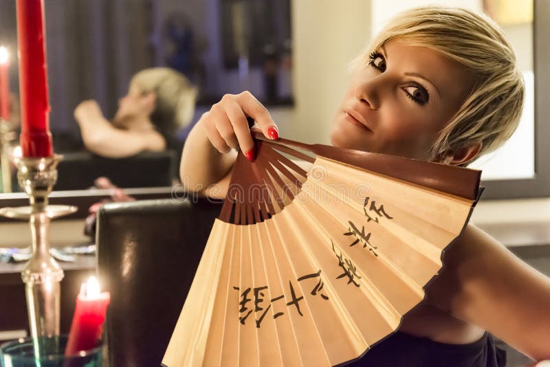 Woman is holding a fan stock image. Image of eyes, adult - 133821183