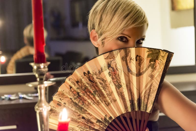 Woman is holding a fan stock image. Image of lifestyle - 133821387