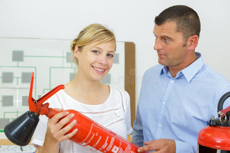 Woman Holding Fire Extinguisher Posing and Smiling Stock Image - Image of trainer, establishment ...