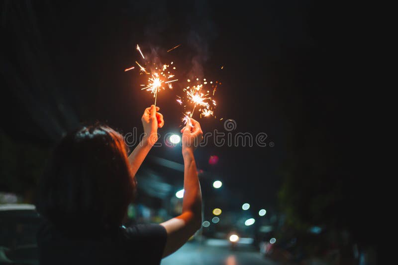 Woman holding fireworks stock image. Image of fireworks - 132602171