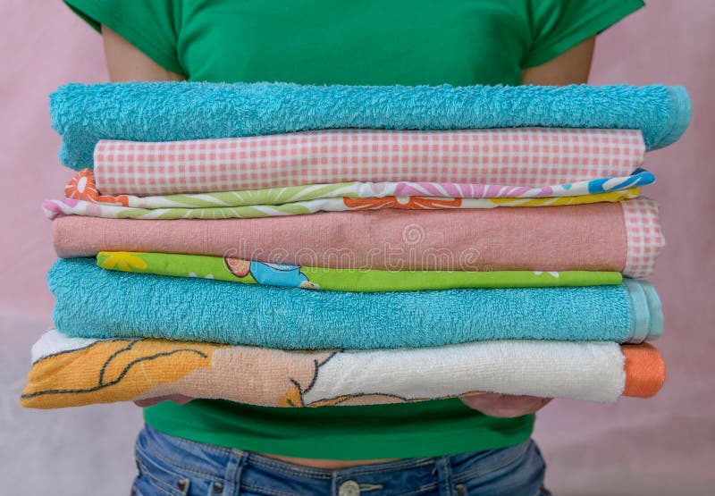 Woman Holding Folded Clothes in Hands Stock Image - Image of heap ...