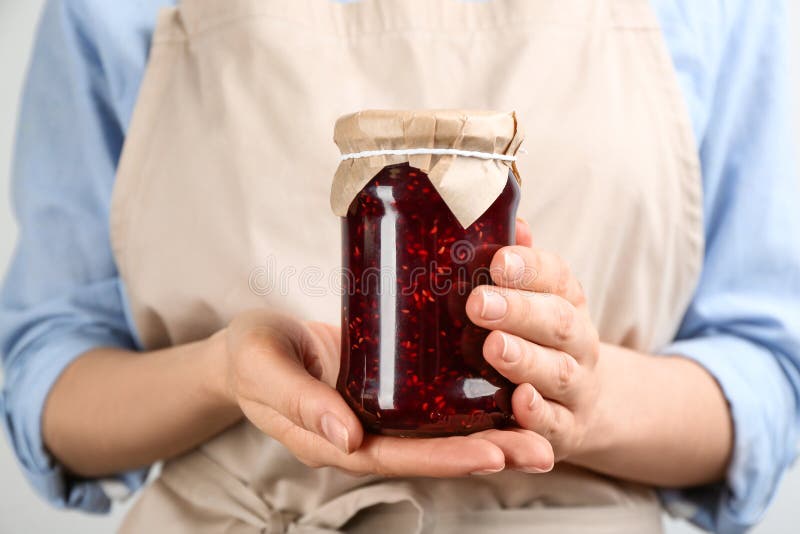 Woman Holding Glass Jar of Raspberry Jam, Closeup Stock Photo - Image ...