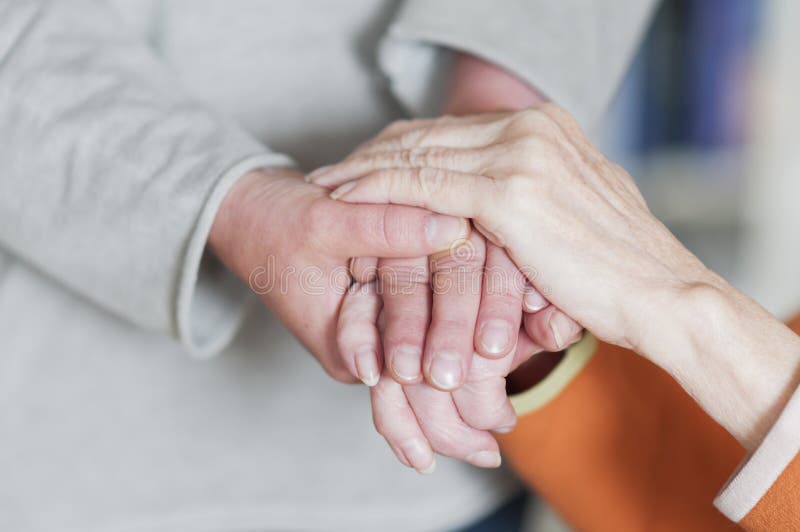 Woman Holding Hand On The Shoulder Of A Senior Woman Stock Photo ...