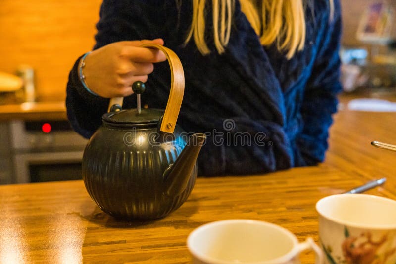 Woman Holding the Handle of a Tea Kettle Stock Photo - Image of holding ...