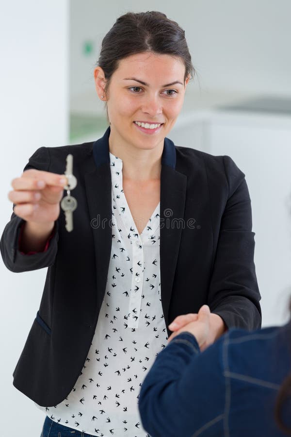 Woman Holding Key Doing Handshake with Client Stock Image - Image of ...
