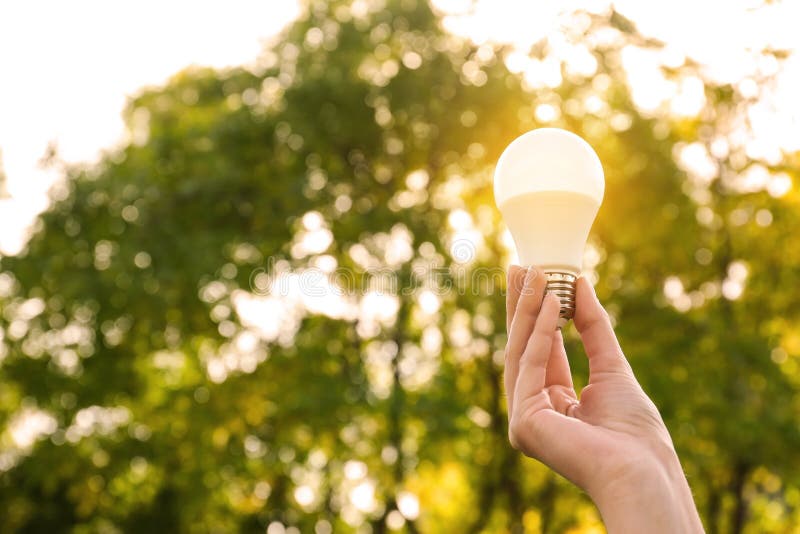 Woman Holding Lamp Bulb Outdoors, Closeup. Stock Image - Image of ...
