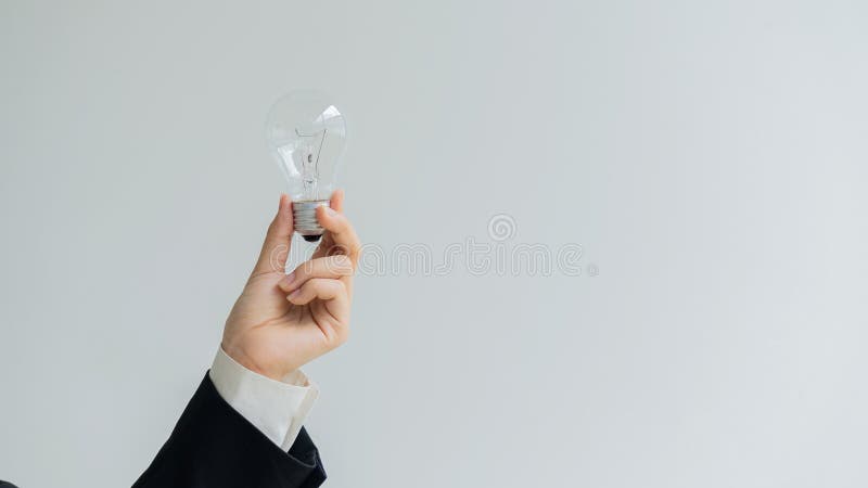 A Woman Holding a Lightbulb at a White Whiteboard that Can Insert Text ...