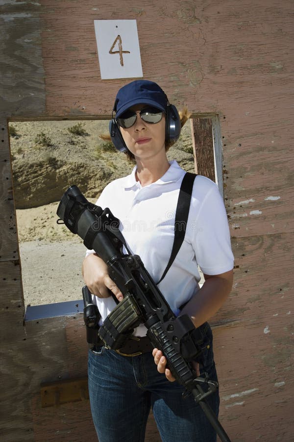 Woman Holding Machine Gun at Firing Range Stock Image - Image of casual ...