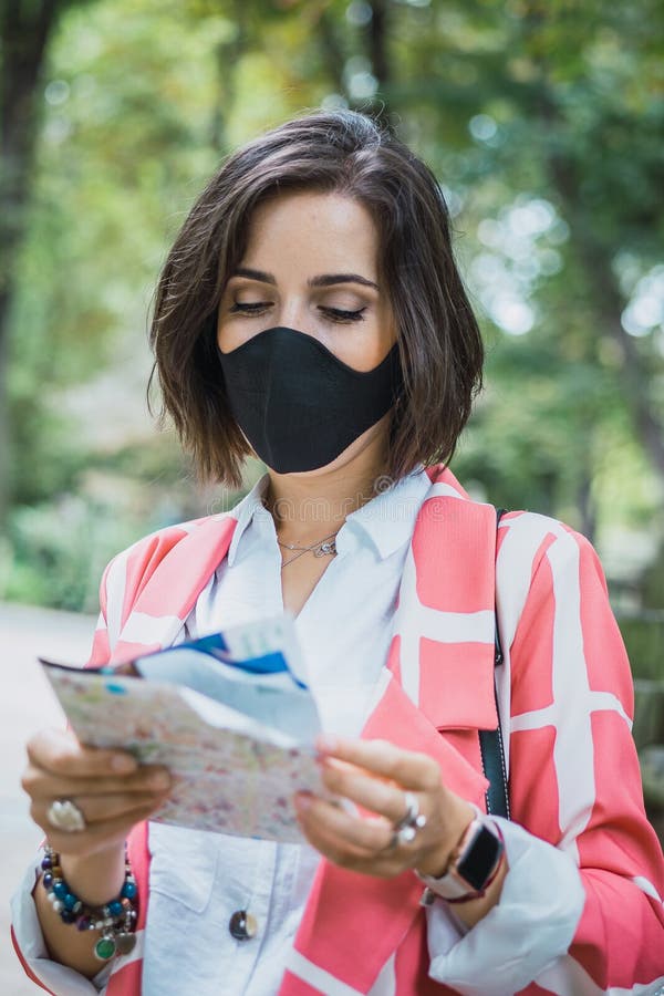 Woman Holding a Map and Wearing a Protective Mask Stock Photo - Image ...