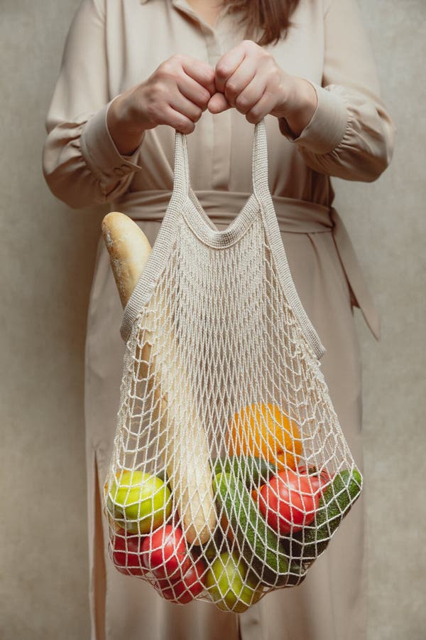 Woman Holding Mesh Shopping Bag. Back View. Stock Photo - Image of ...