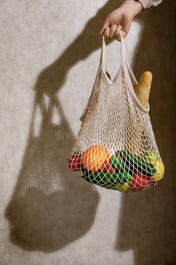 Woman Holding Mesh Shopping Bag. Back View. Stock Image - Image of ...