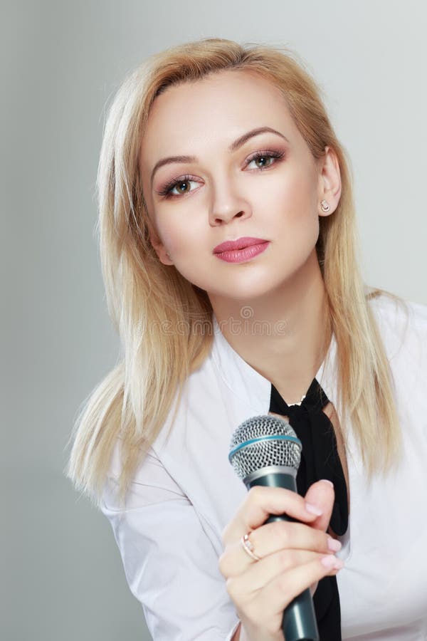 Woman holding microphone stock image. Image of interview - 89087717
