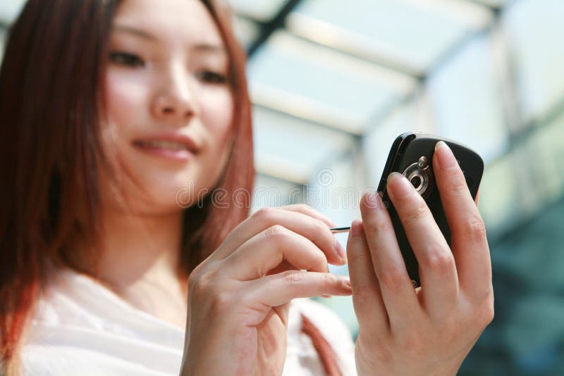 Woman holding mobile phone stock image. Image of female - 9354411