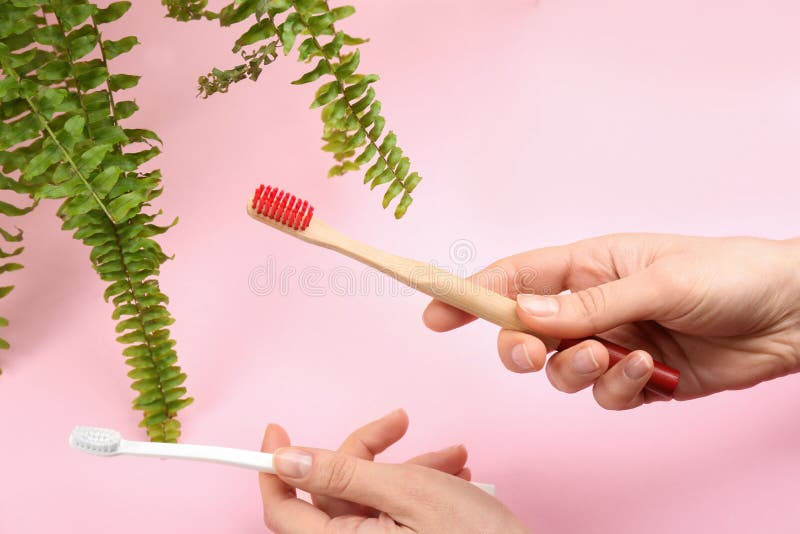 Woman Holding Natural Bamboo and Plastic Toothbrushes on Background ... Woman Holding Natural Bamboo and Plastic Toothbrushes on Background ...