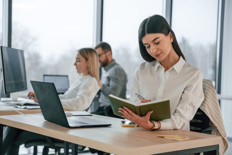 Woman is Holding Notepad. Successful Team are Working Together in the ...