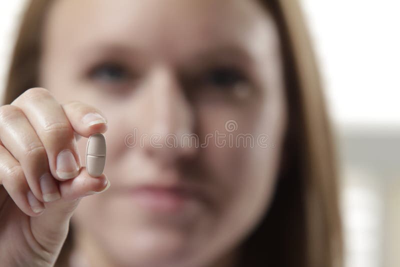 Woman Holding a Pill, Face Out of Focus Stock Image - Image of pill ...