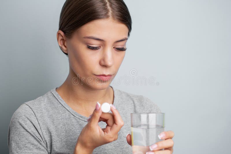 Woman Holding Pill And Glass Water Taking Medicine From Headache