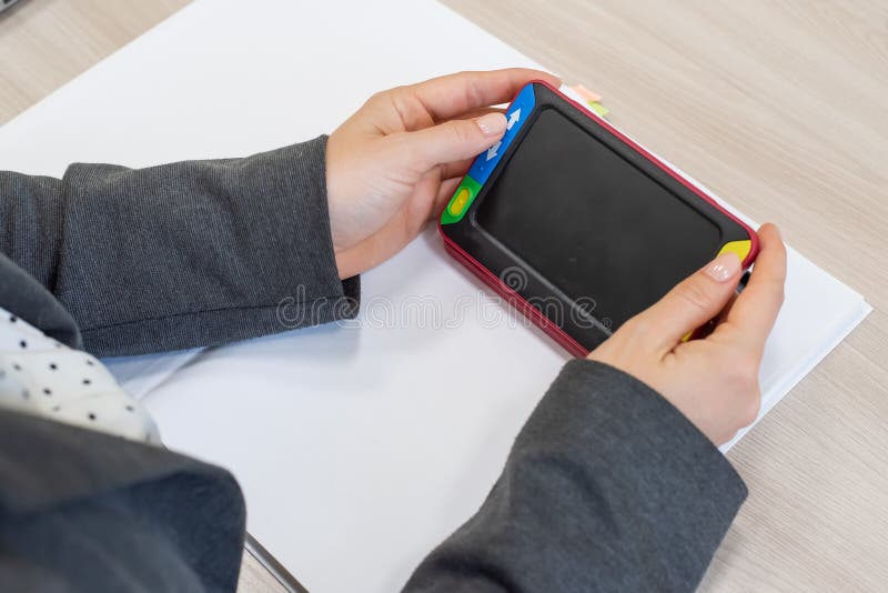 The Woman is Holding a Reading Device for the Visually Impaired ...