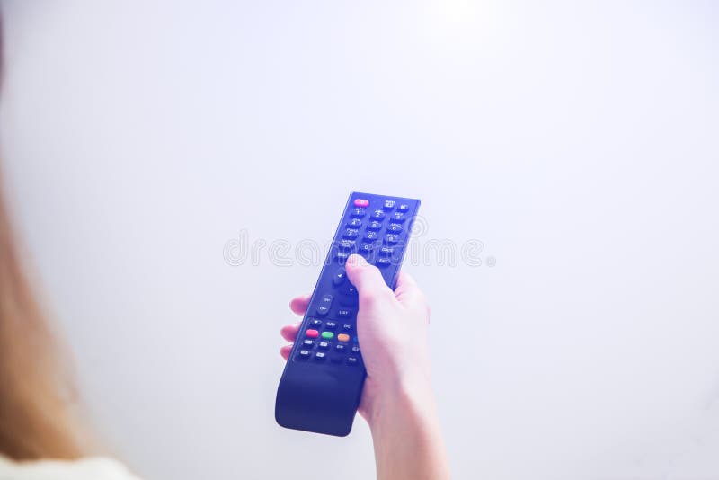 Woman is Holding the Remote Control in Her Hands. Using TV at Home ...