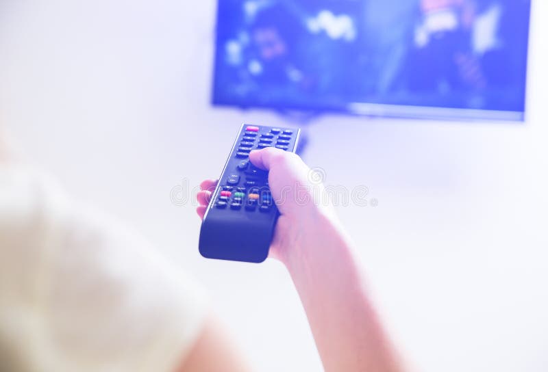 Woman is Holding the Remote Control in Her Hands. Using TV at Home ...
