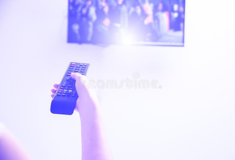 Woman is Holding the Remote Control in Her Hands. Using TV at Home ...