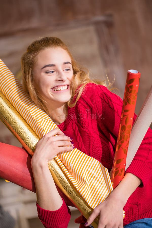 Woman Holding Rolls of Wrapping Paper Stock Image - Image of young ...