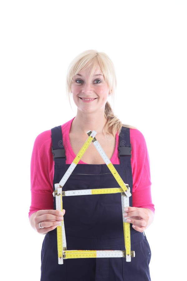 Woman Holding a Ruler in the Form of a House Stock Photo - Image of ...