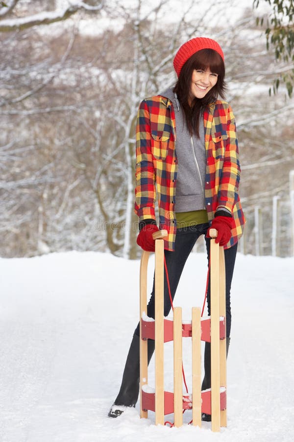 Woman Holding Sledge in Snowy Landscape Stock Photo - Image of camera ...