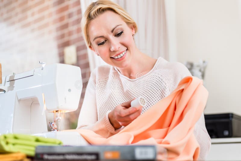 Woman Holding Spool and Fabric Stock Photo - Image of needlework ...