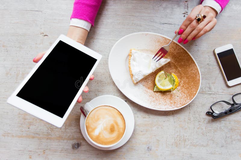 Woman Holding Tablet Computer while Sitting in Cafe Stock Image - Image ...