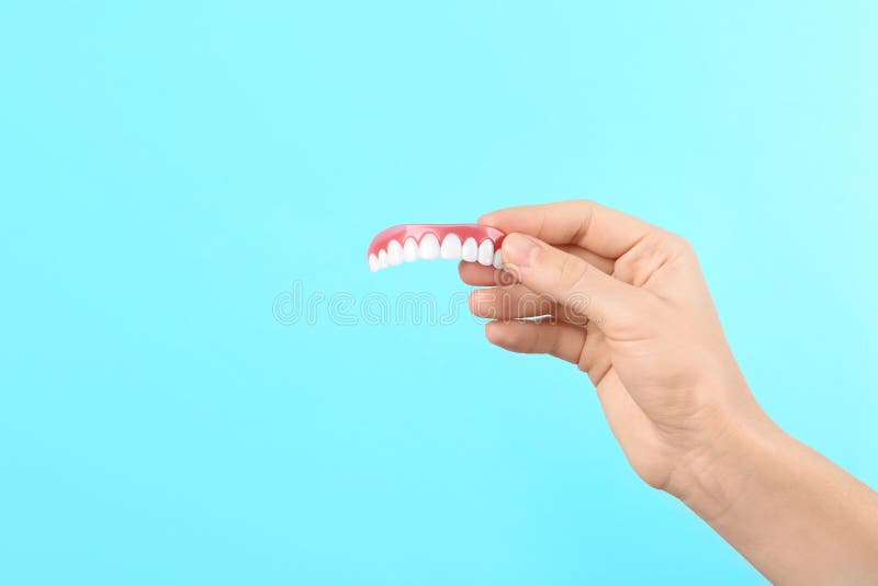 Woman Holding Teeth Cover on Color Background. Stock Image - Image of ...