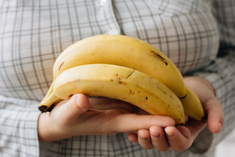 Woman Holding Three Ripe Bananas in Arms Stock Photo - Image of fresh ...