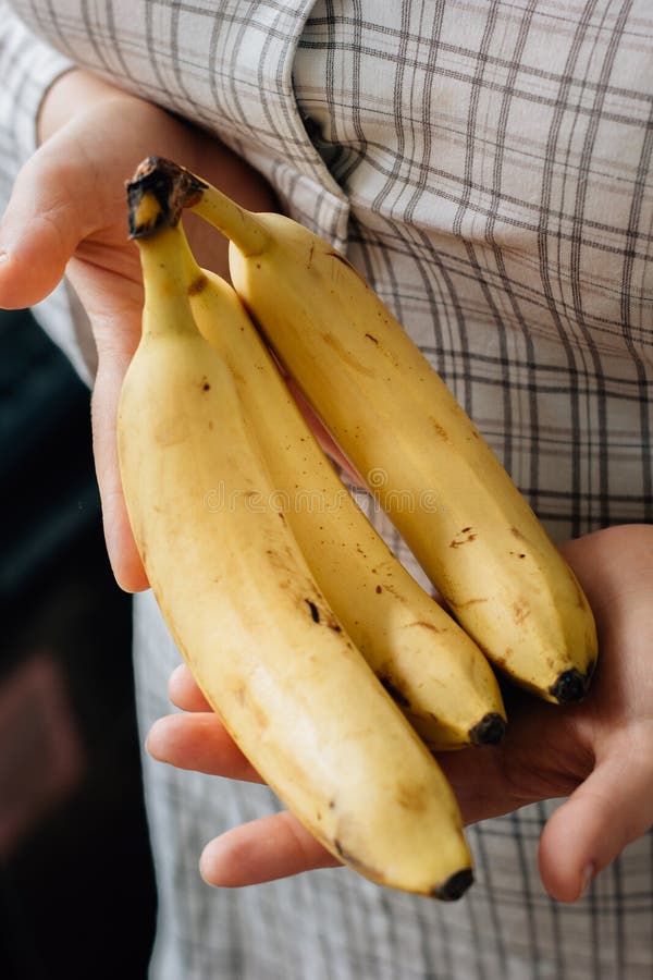 Woman Holding Three Ripe Bananas in Arms Stock Photo - Image of female ...