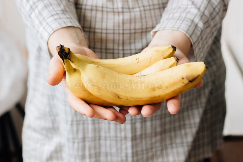 Woman Holding Three Ripe Bananas in Arms Stock Photo - Image of arms ...