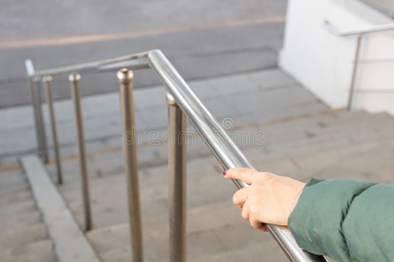 A Man Holding on To a Handrail in a Passage Stock Photo - Image of ...