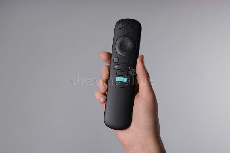 Woman Holding TV Remote Control on Grey Background, Closeup Stock Photo ...