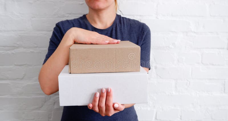 A Woman Holds Boxes in Her Hands. Close-up. Place for Text Stock Photo ...