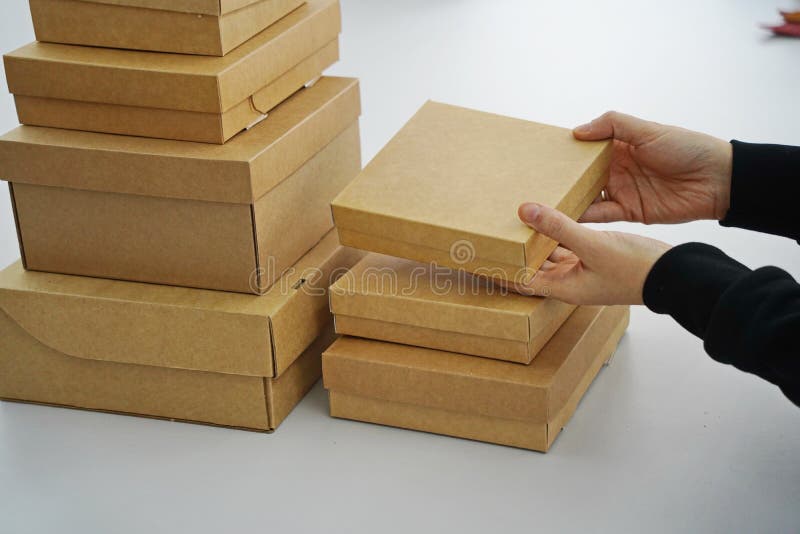A Woman Holds Cardboard Boxes for Parcels and Delivery Stock Photo ...