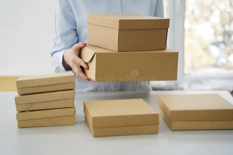A Woman Holds Cardboard Boxes for Parcels and Delivery Stock Image ...