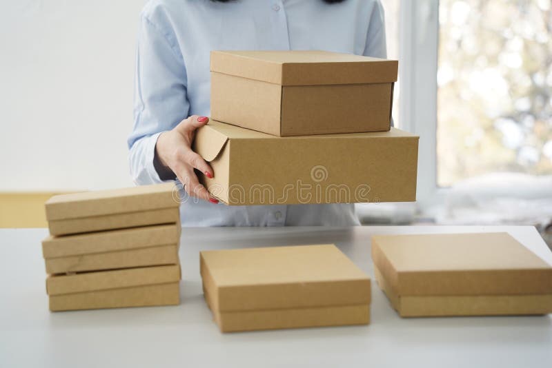 A Woman Holds Cardboard Boxes for Parcels and Delivery Stock Image ...