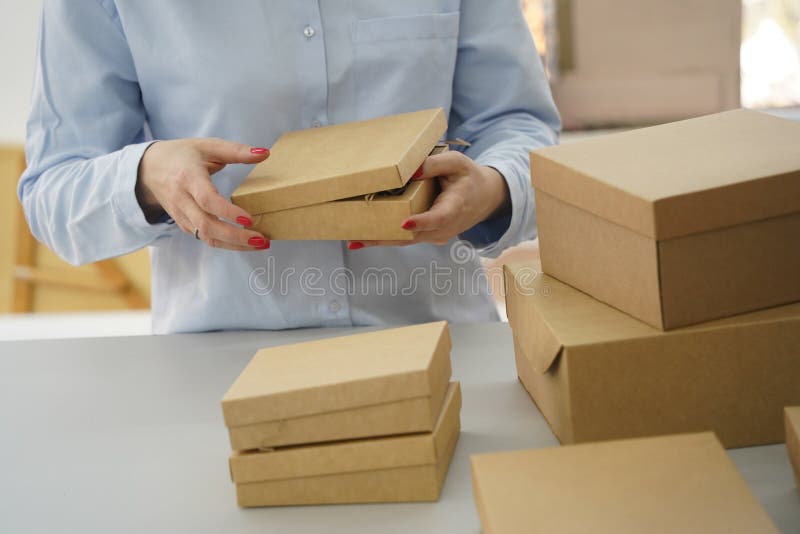 A Woman Holds Cardboard Boxes for Parcels and Delivery Stock Photo ...
