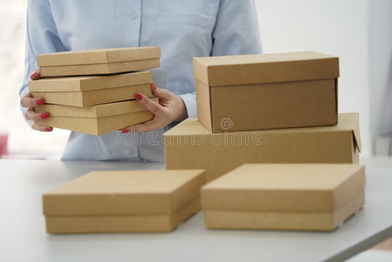 A Woman Holds Cardboard Boxes for Parcels and Delivery Stock Photo ...