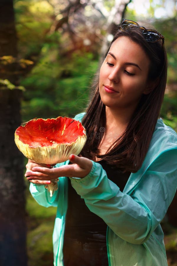 Woman Holds Mushroom, Toadstool Stock Photo - Image of lens, flare ...