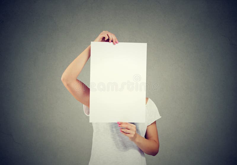 A Woman Holds a Sheet of White Paper in Front of Her Face Stock Photo ...