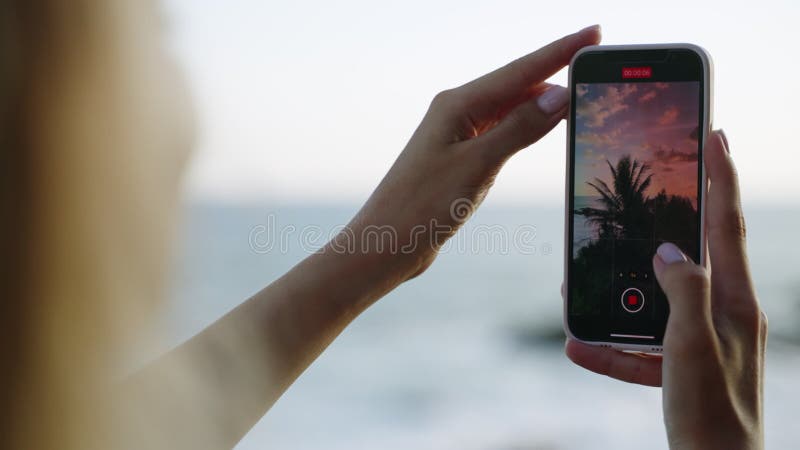 Woman Holds Smartphone and Recording Nature of Tropical Island. Phone ... Woman Holds Smartphone and Recording Nature of Tropical Island. Phone ...
