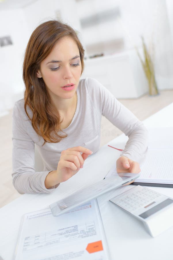 Woman at Home Doing Paperwork Using Tablet Stock Image - Image of ...
