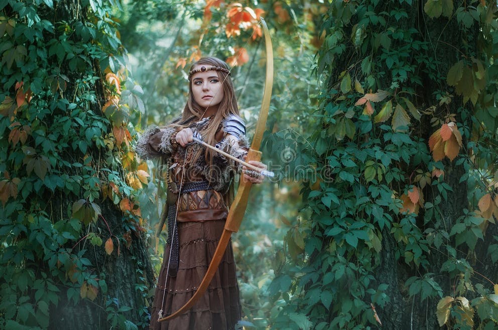 Woman Hunter with a Bow in Hand, Taking Aim at His Prey in the Forest ...