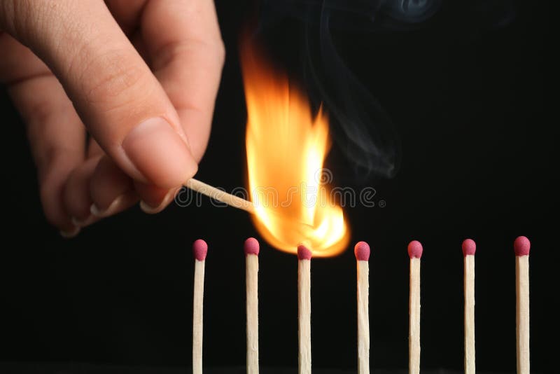 A woman igniting a candle stock image. Image of dark - 11495165